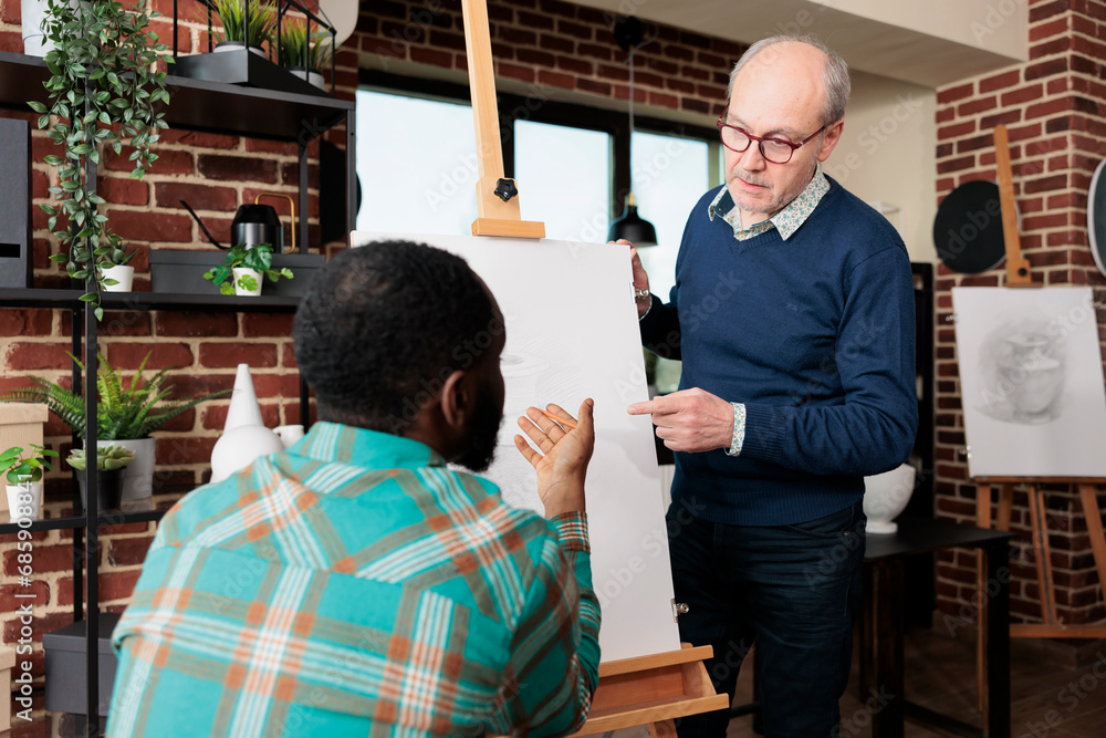 People connecting while learning new skills, two diverse men looking at ...