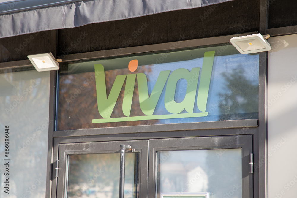 Foto de vival shop supermarket logo text and brand sign store v facade ...