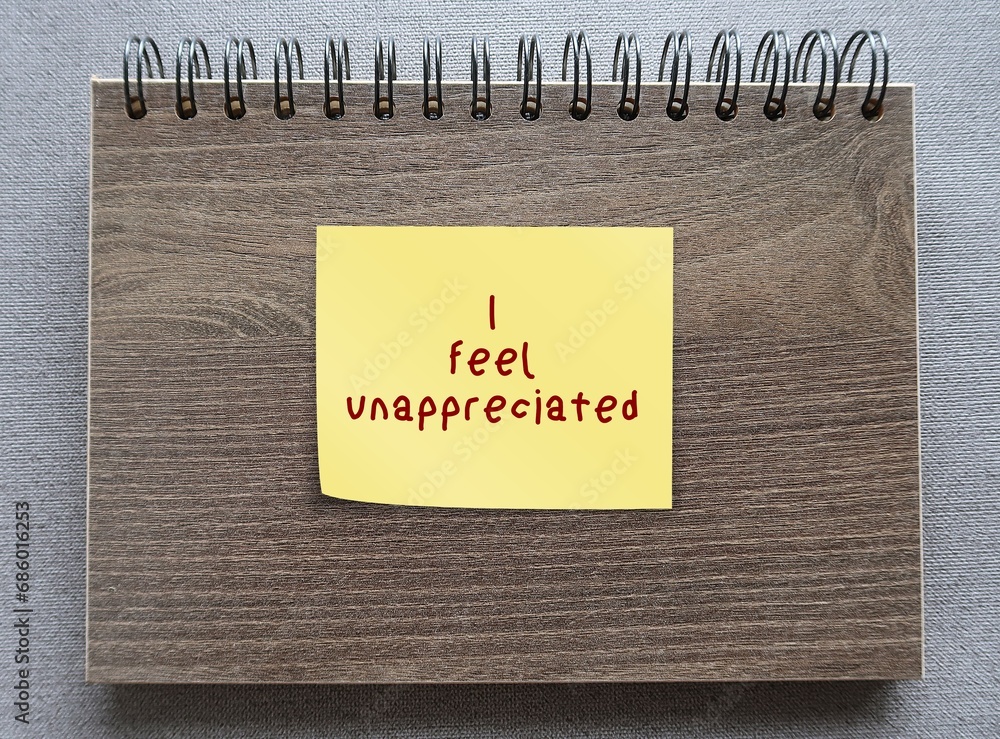 Office notebook with text written note I FEEL UNAPPRECIATED - feeling ...