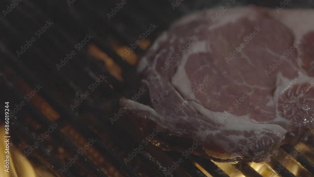 Roast beef. Beef steak on grill with flames. Rib-eye steaks cooking on ...