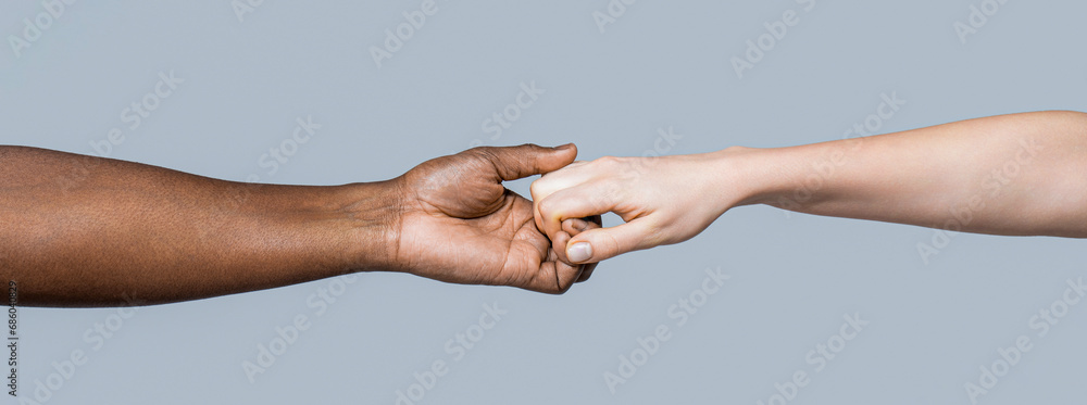 Giving a helping hand to another. Woman and african woman hand. Black ...