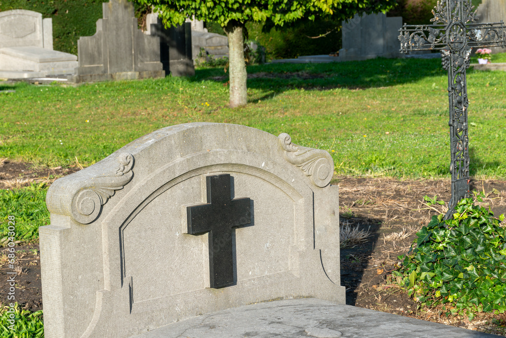 cemetery sculpture, a grave of the deceased with a cross and two little ...
