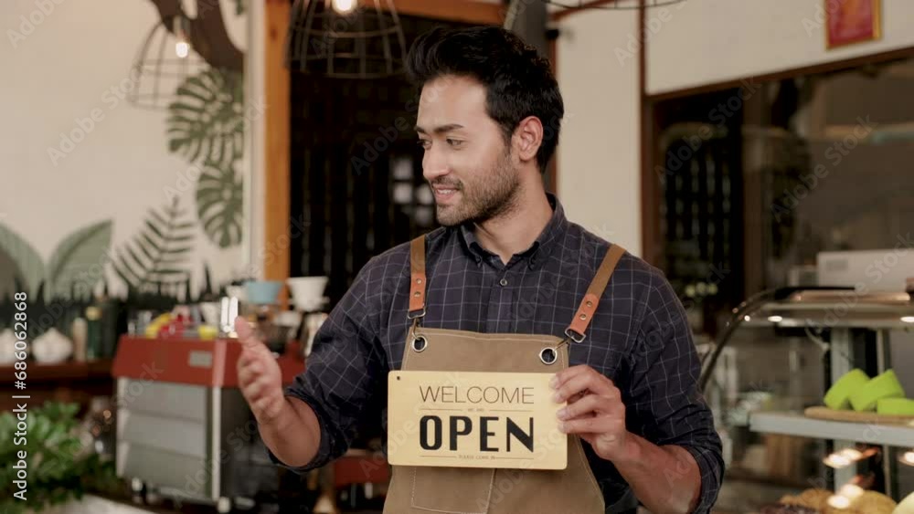 Young attractive Indian barista male cafe entrepreneur start-up holding ...