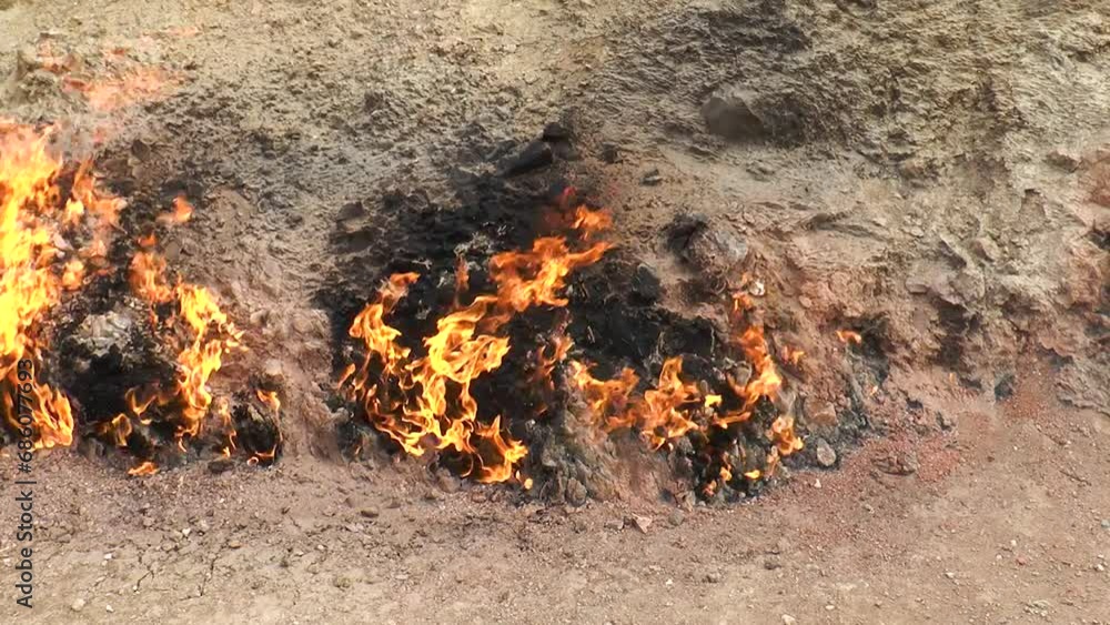 Ecology, global warming. Fire. Flames of burning gas from the surface ...