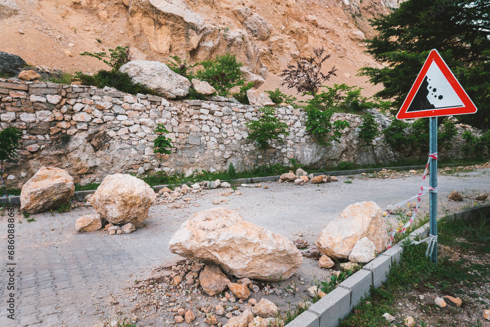 Rockfall on road. Large rocks of rock fell on the asphalt road ...