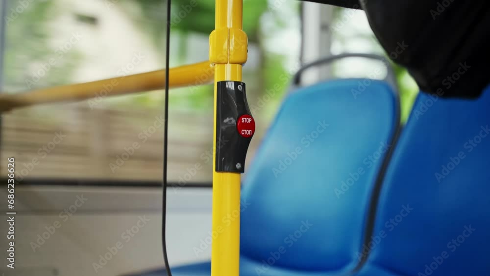 Close up shot man stands up to push red stop button on handrail in ...