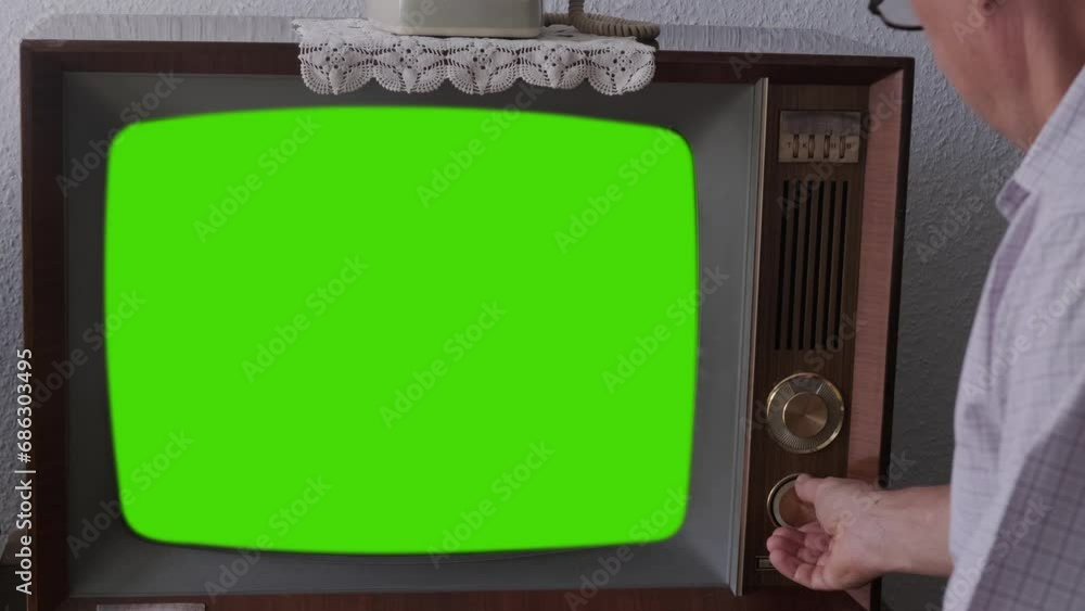 male Hand turns on TV power button, adjusts the volume control old ...