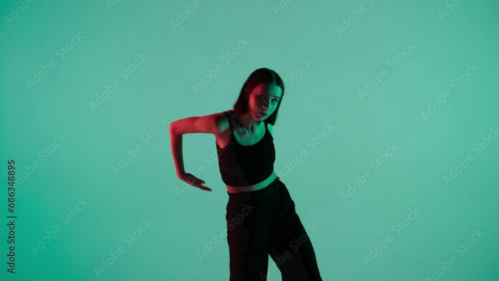 In the frame on a blue, light background. Dances young, beautiful girl ...