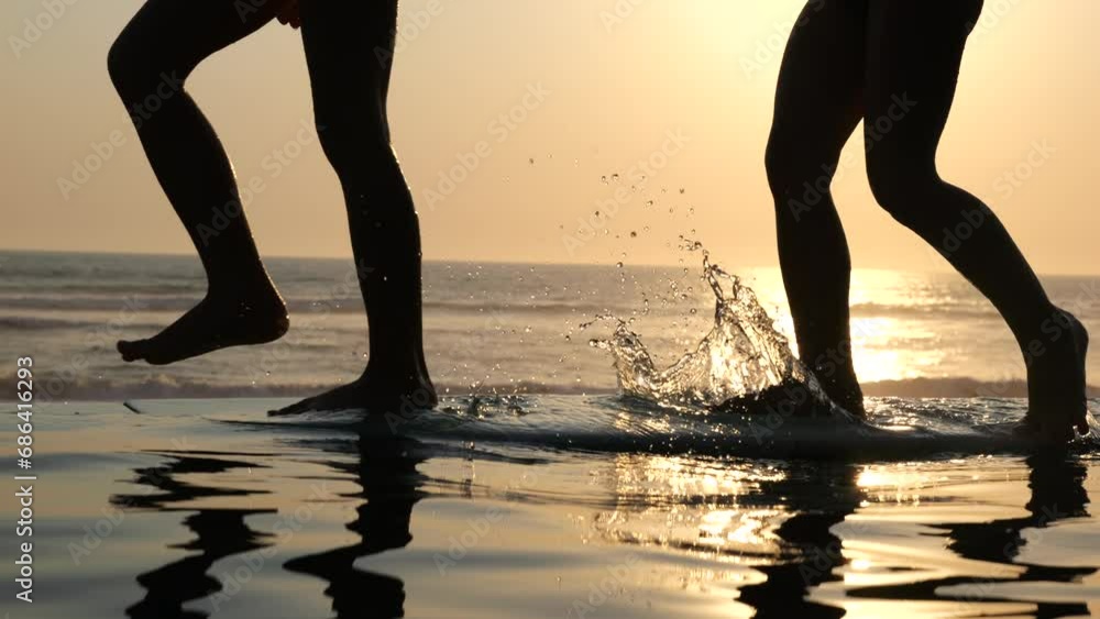 Little childrens feet splash happily along ocean shore in sunset ...