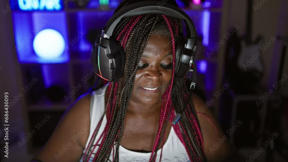 Glowing african american woman streamer in the heart of the gaming room ...