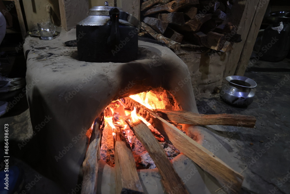 a traditional stove buring the fire in a Gurung village in Ghandruk ...