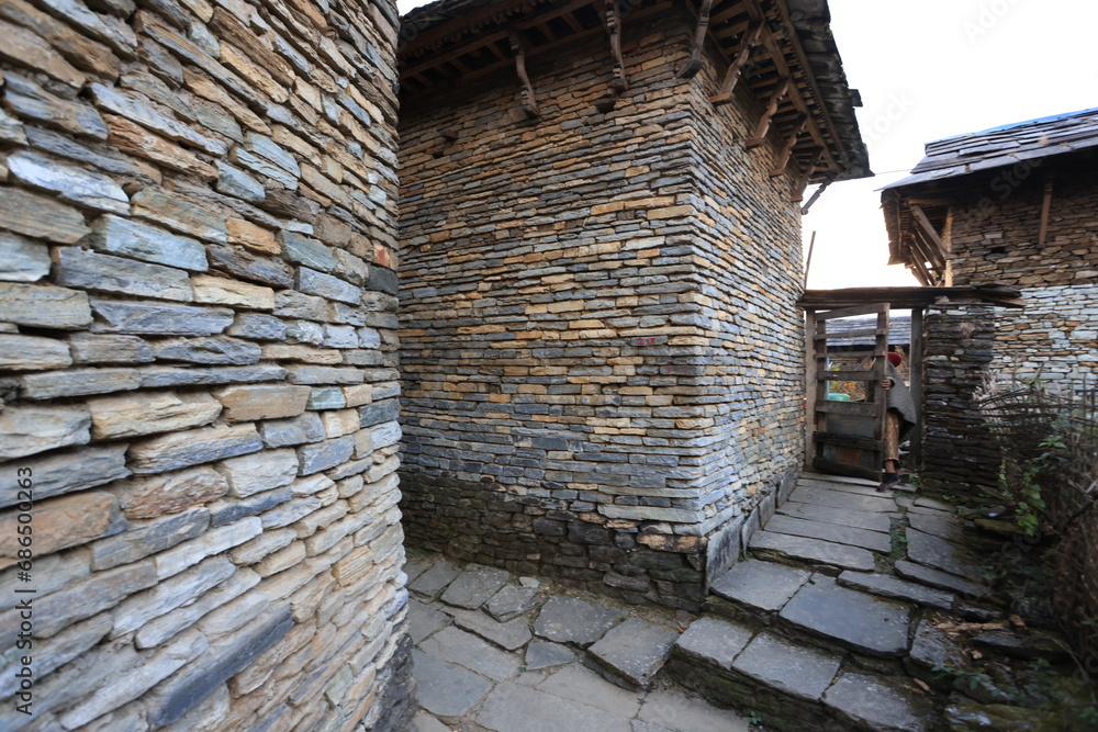 house of traditional rock wall in a Gurung village in Ghandruk town ...