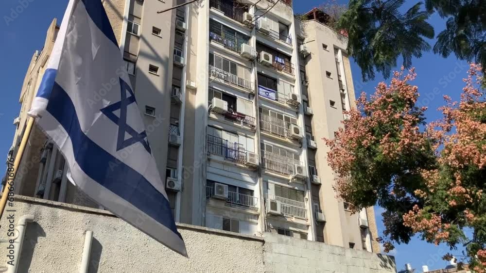 Residential area Gush Dan. Israeli flag in the wind near a residential ...
