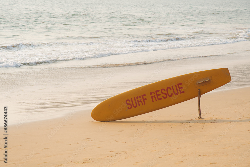 Yellow lifeguard surf rescue board by the ocean on the sand Stock Photo ...