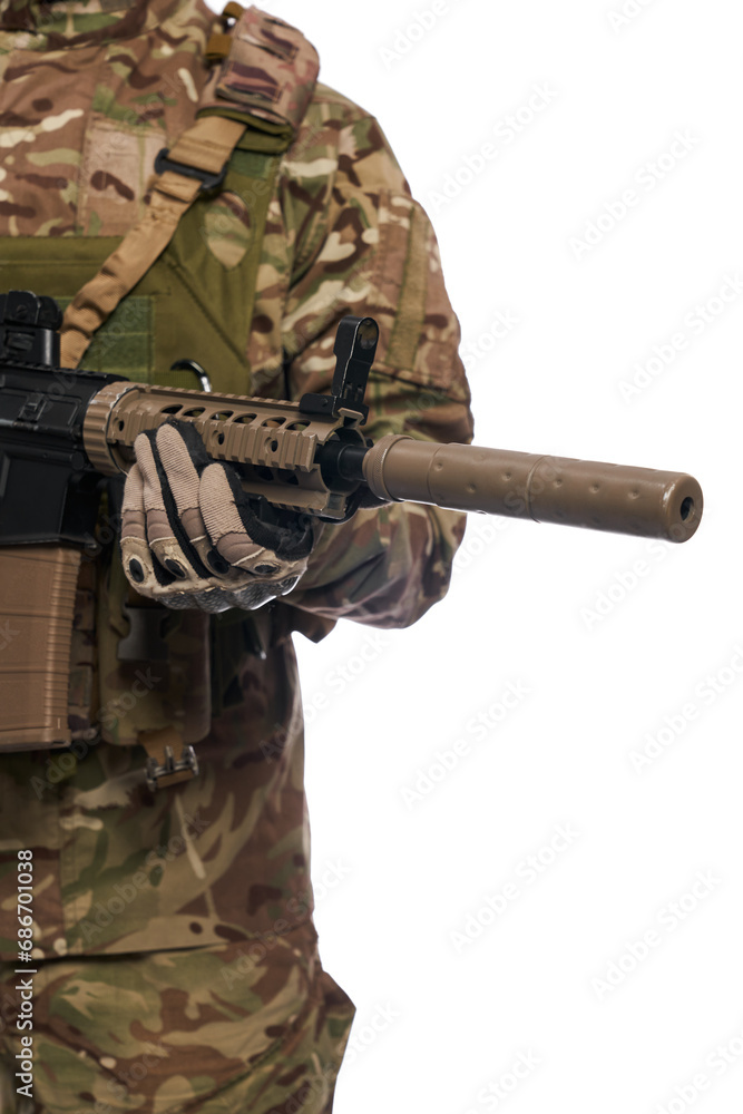 Anonymous army man in tactical gloves holding assault rifle on chest ...