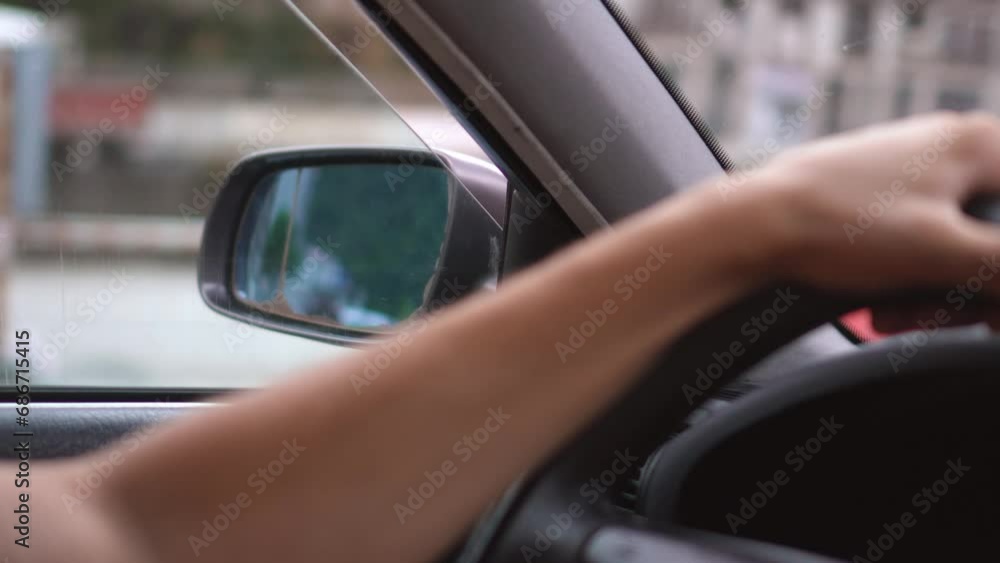 Man driving car side view inside cabin . Close-up of driver's hands ...