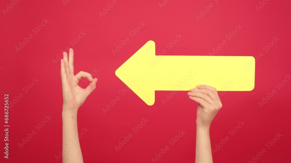 Woman hands holding yellow arrow points to Okay gesture, demonstrates ...
