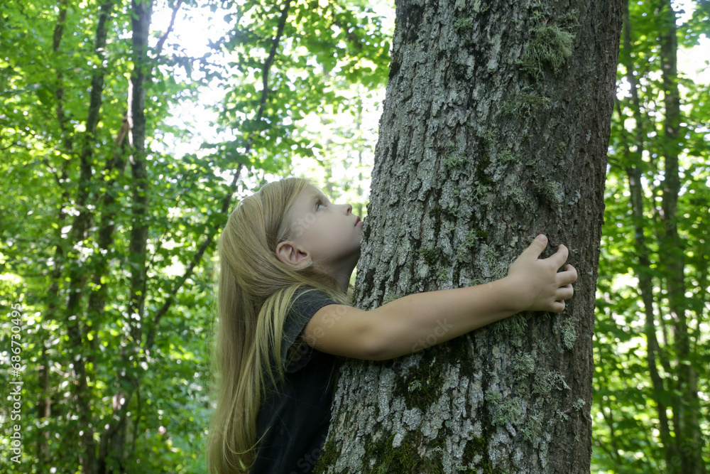 Cute little girl hugging tree. Hugging and touching trees provide rich ...