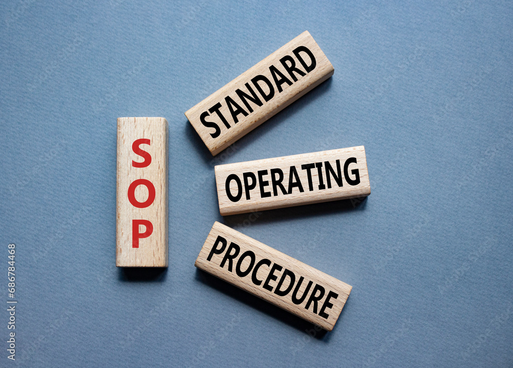 SOP - Standard Operating Procedure symbol. Wooden blocks with word SLA ...