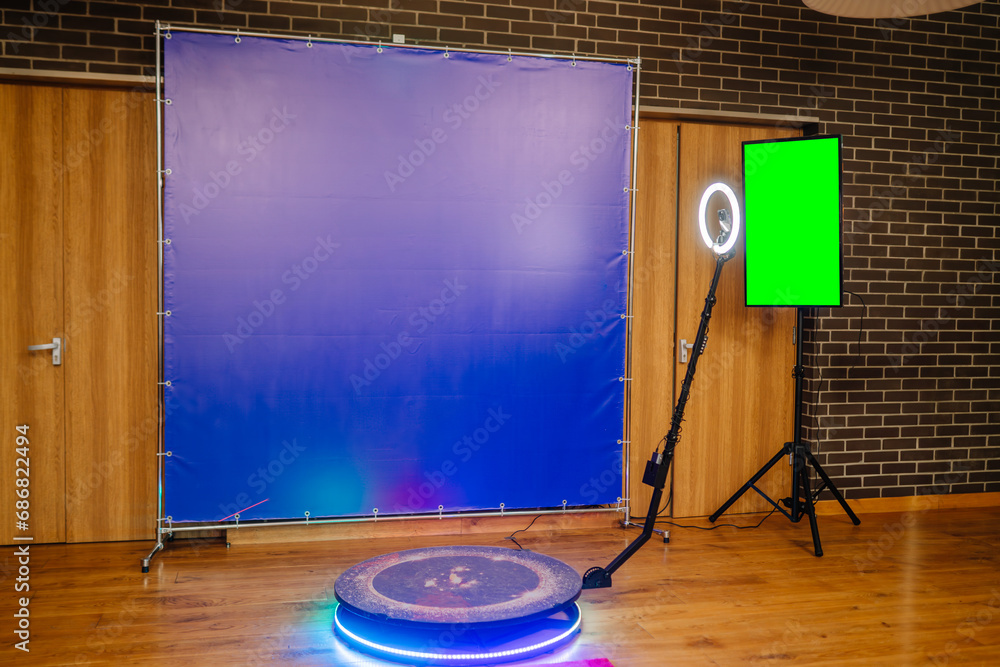 Defocused view of a 360 photo booth used at an event. Banner and TV ...