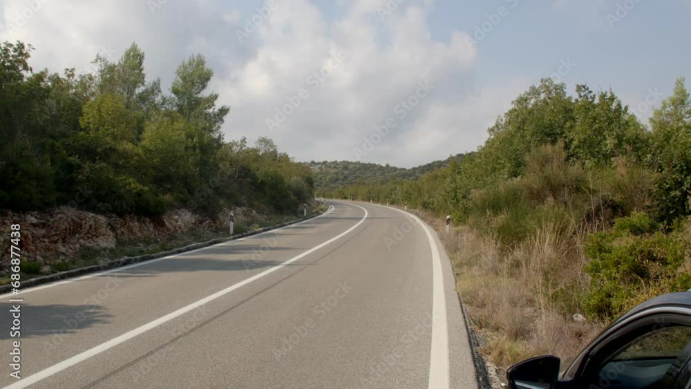 Car has come to a stop on the shoulder of a deserted road with white ...