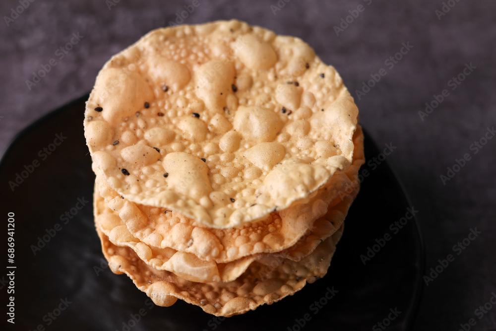 Papadam a traditional indian snack. papad or papadum in raw dried form ...