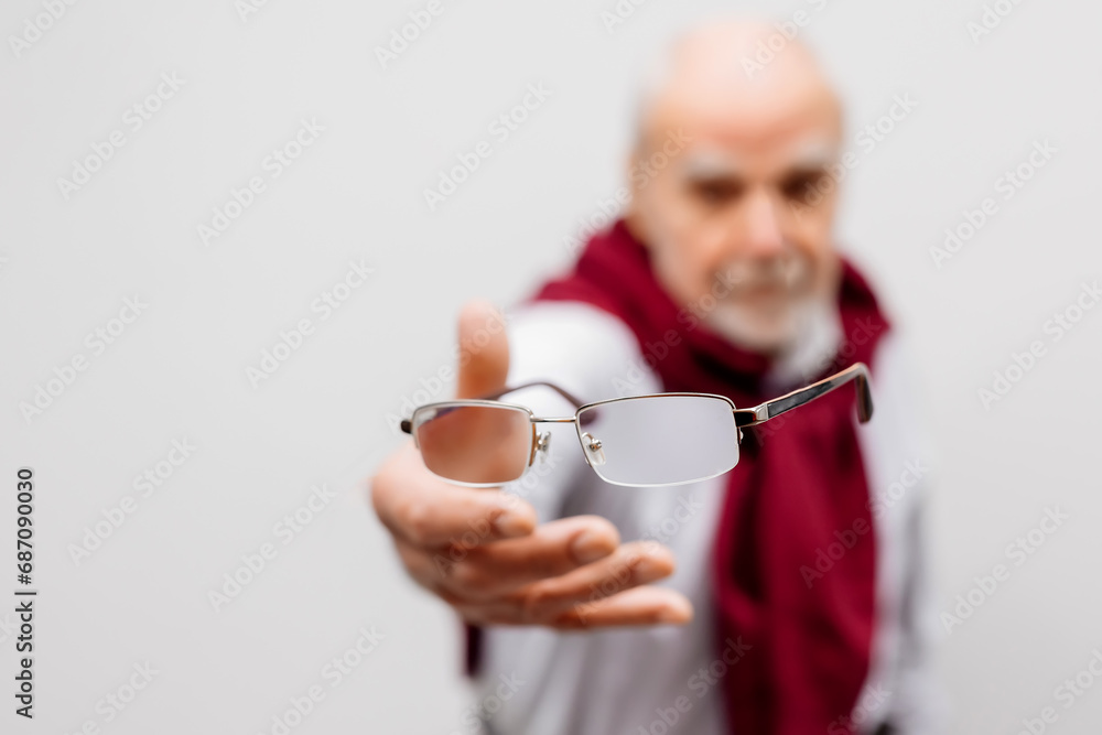 Vision correction and treatment. A mature man throws away his glasses ...
