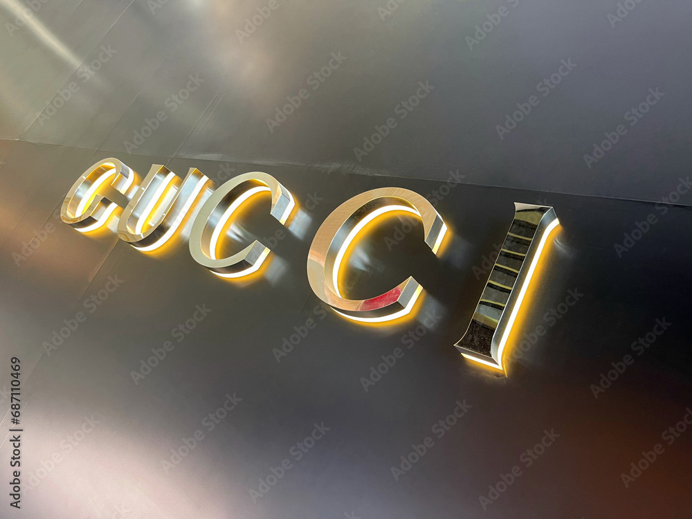Stylish illuminated logo GUCCI close-up. Luxury fashion house. Premium ...