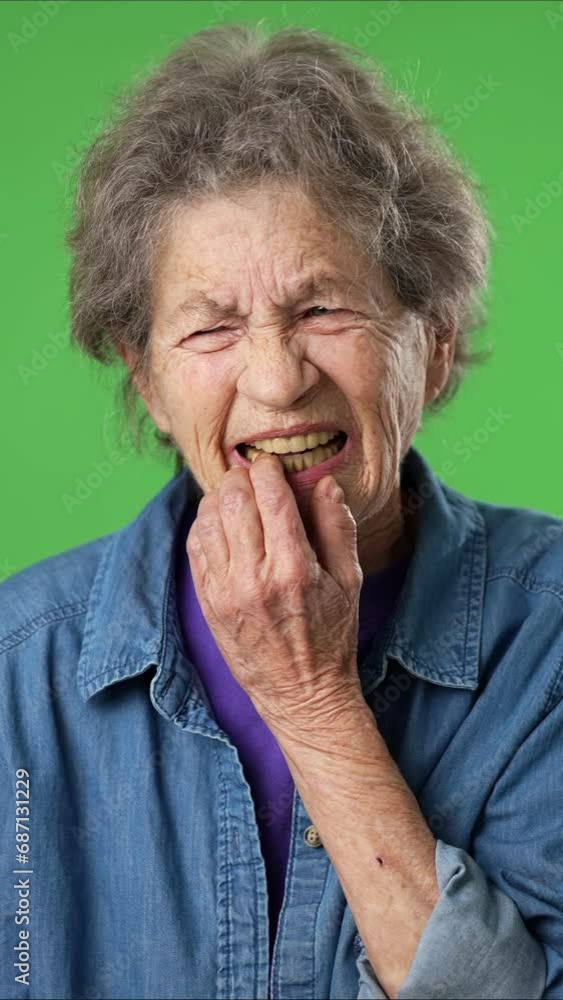 Vertical video portrait of elderly mature old woman with tooth dental ...