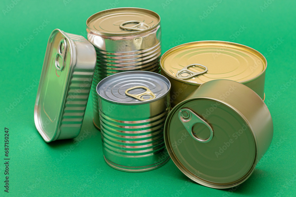 A Group of Stacked Tin Cans with Blank Edges on Green Background ...