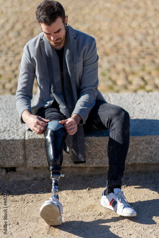 Young man missing a leg putting on a prosthetic leg Stock Photo | Adobe ...