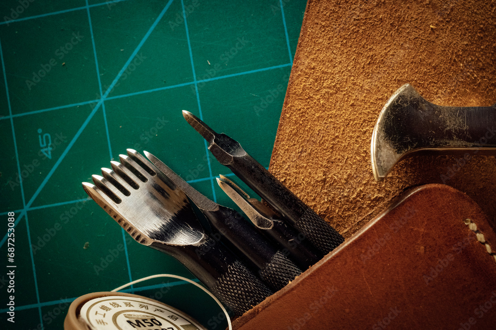 The worn leather case, carefully crafted by hand in a small studio ...