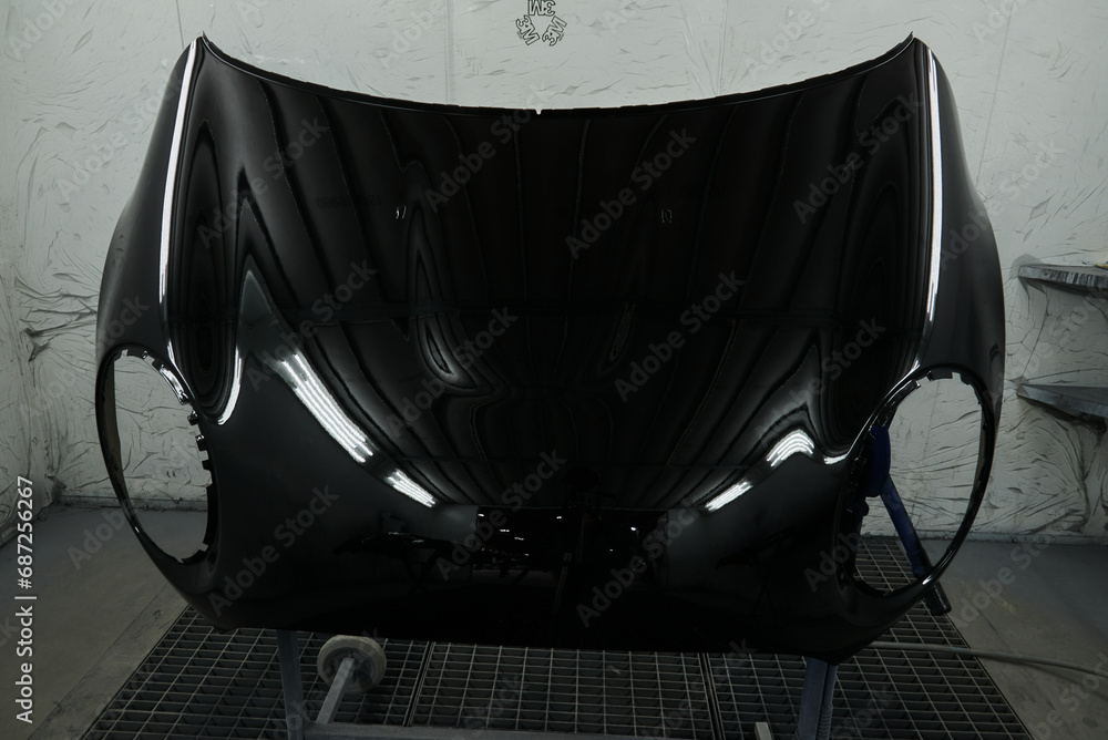 The photograph captures the scene of an automotive workshop, showcasing ...