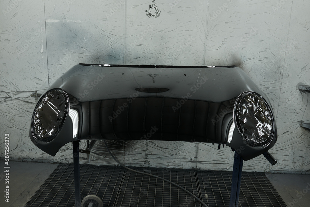 The photograph captures the scene of an automotive workshop, showcasing ...