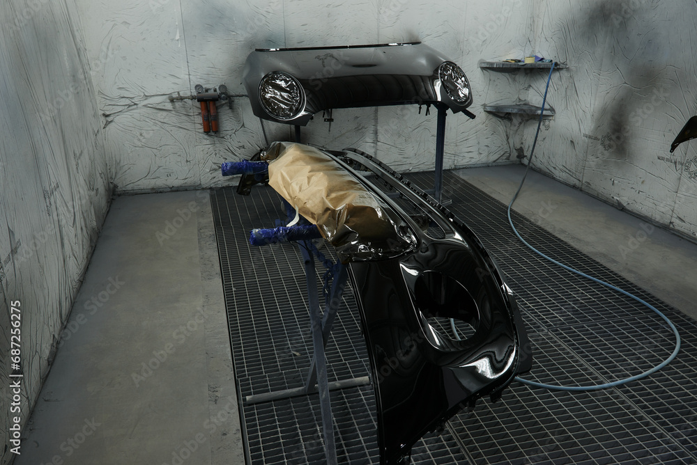 The photograph captures the scene of an automotive workshop, showcasing ...