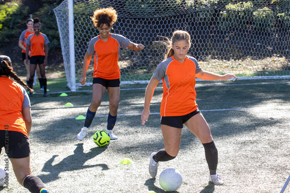 Group of five female soccer players on a team warming up and running ...