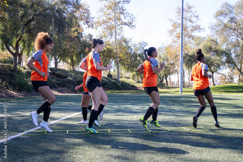 Group of five female soccer players on a team warming up and running ...