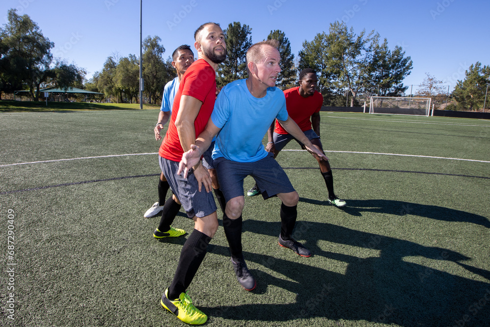 Soccer players work together as a team playing the game together. The ...