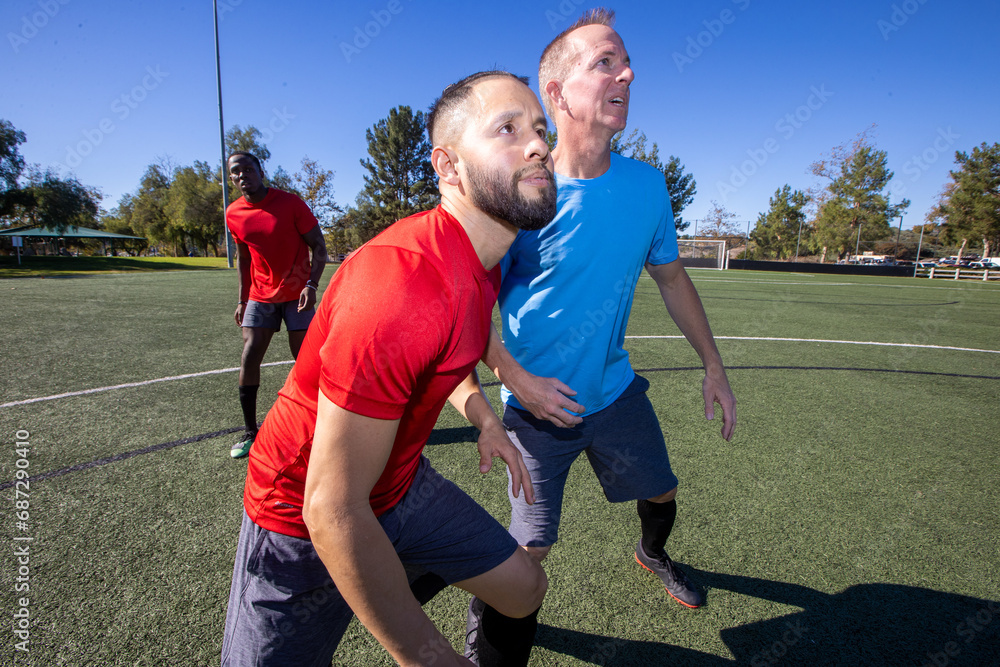 Soccer players work together as a team playing the game together. The ...