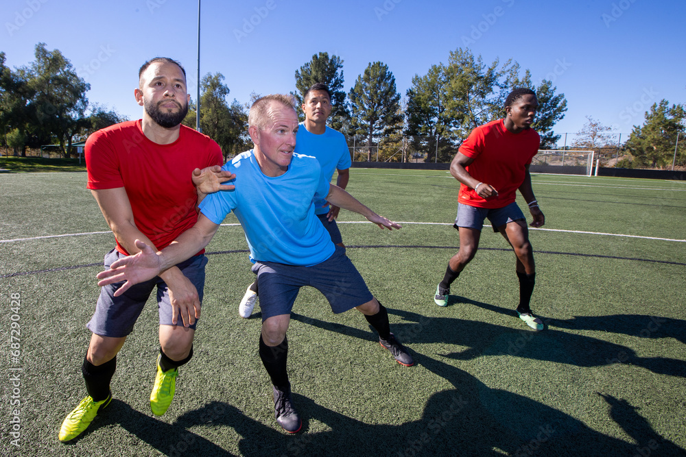 Soccer players work together as a team playing the game together. The ...