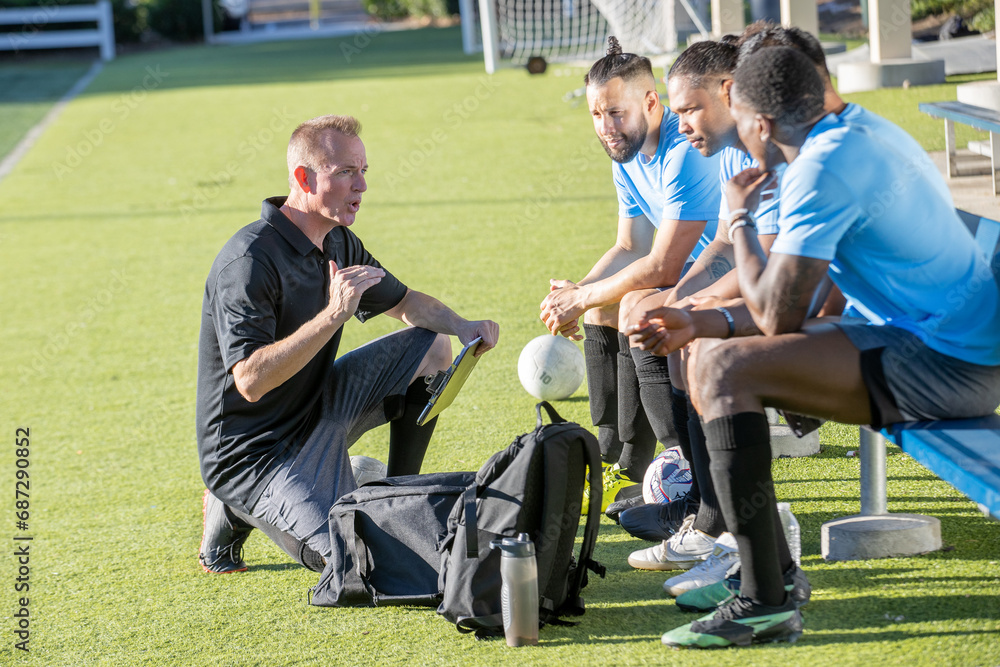 Soccer players work together as a team playing the game together. The ...