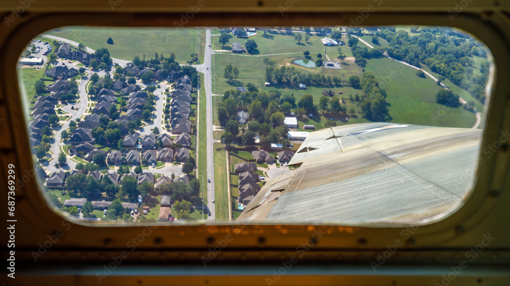 looking out left window of vintage military bomber during a left bank ...