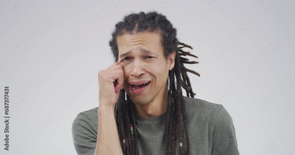 Sad, crying and face of a man with depression in studio isolated on a ...
