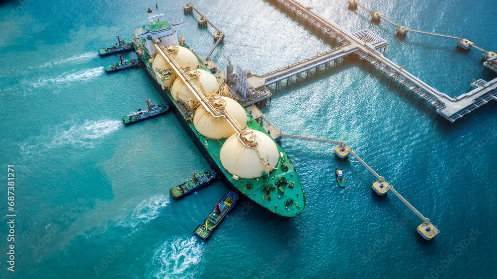 LNG (Liquefied natural gas) tanker anchored in Gas terminal gas tanks ...