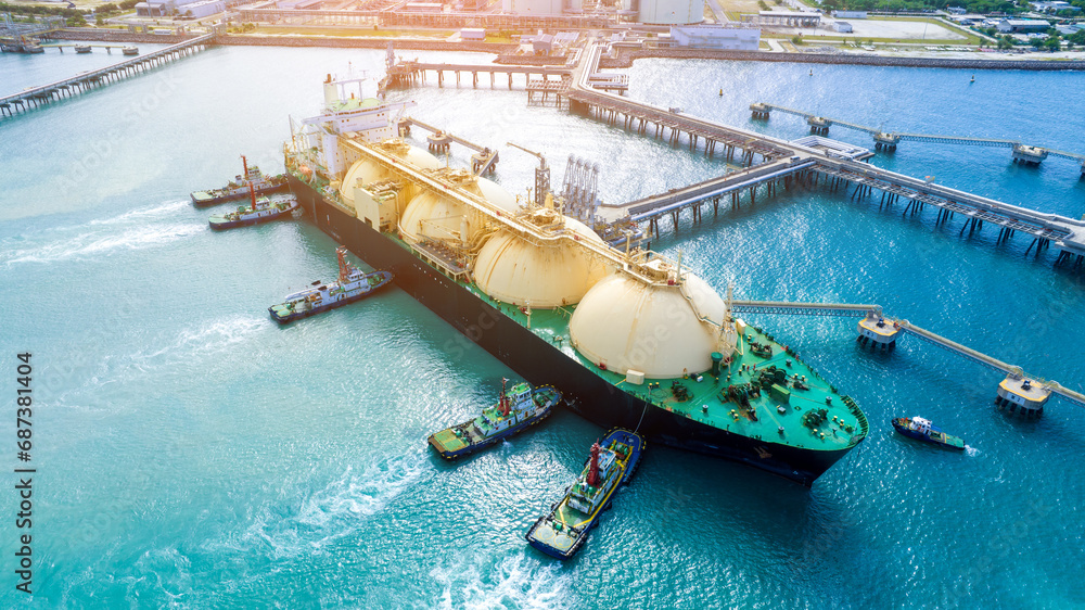 LNG (Liquefied natural gas) tanker anchored in Gas terminal gas tanks ...