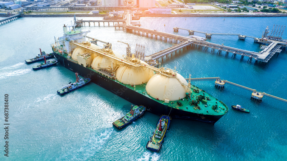LNG (Liquefied natural gas) tanker anchored in Gas terminal gas tanks ...