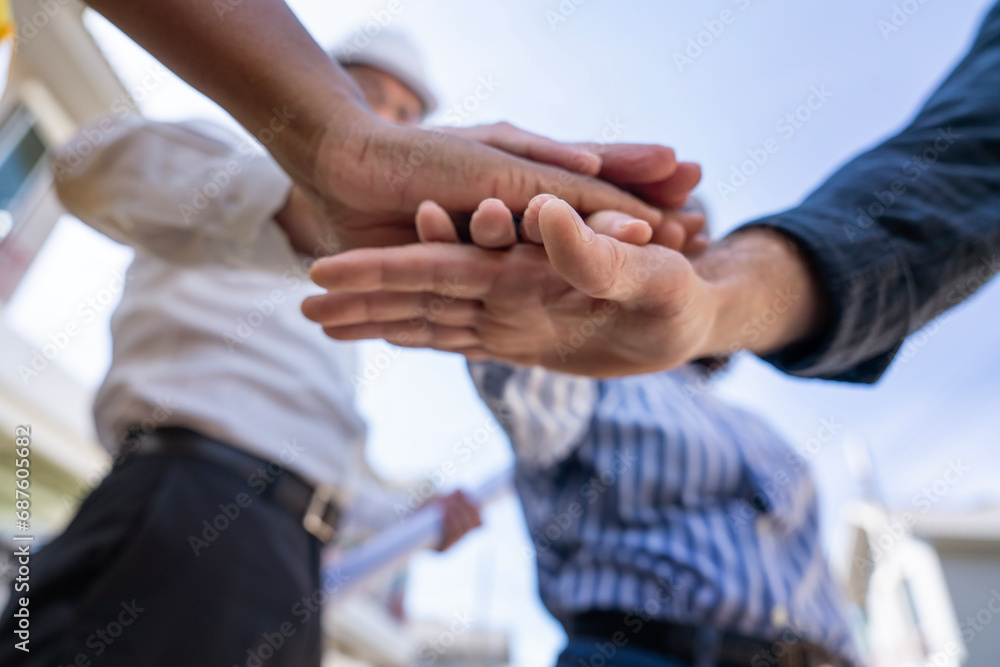 group of employees hand in hand to show the best teamwork collaboration ...