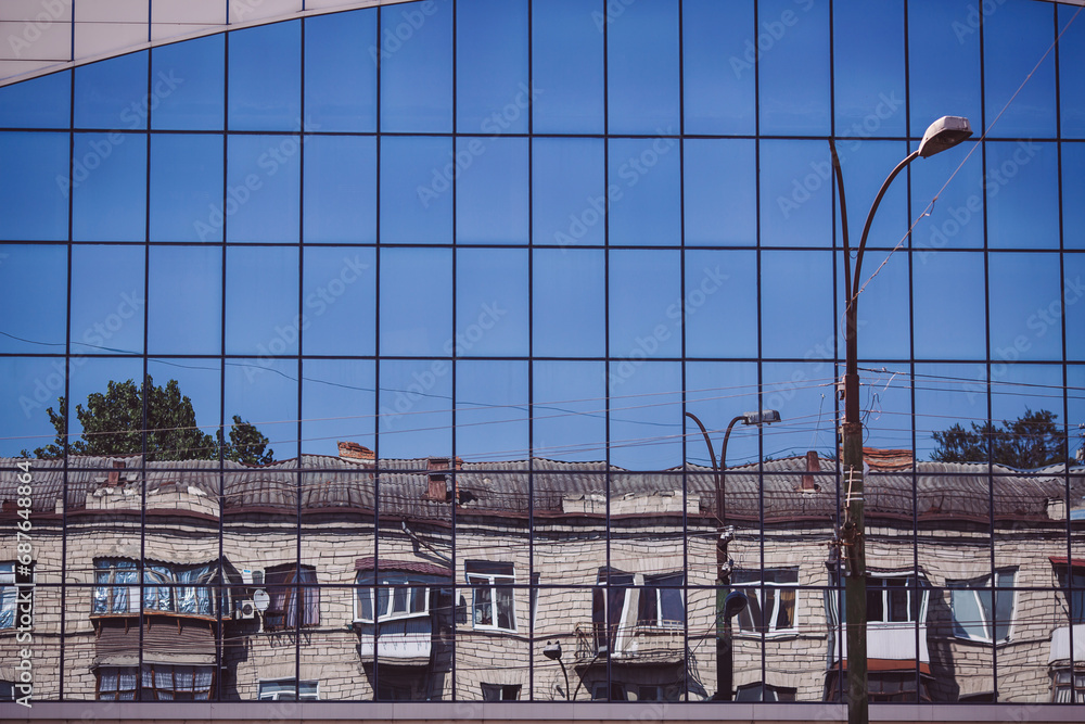 Old brick building reflecting with distortion in windows of a modern ...