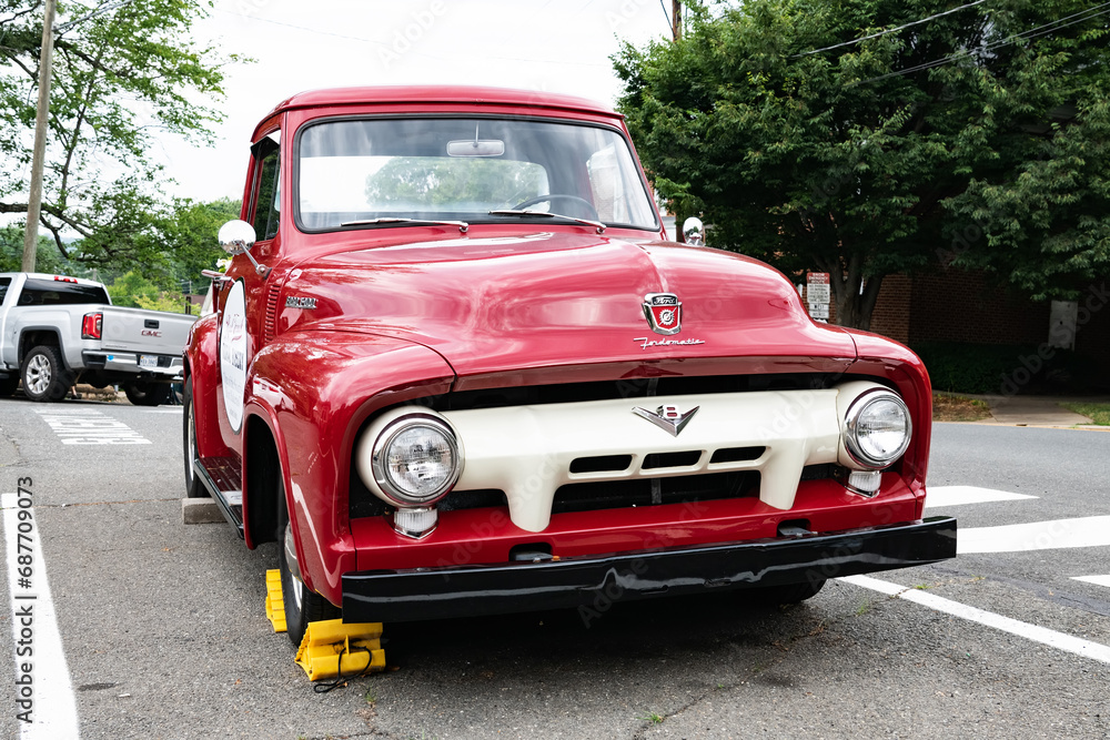Restored red pickup truck from the 50s, Ford F100 in the parking lot ...