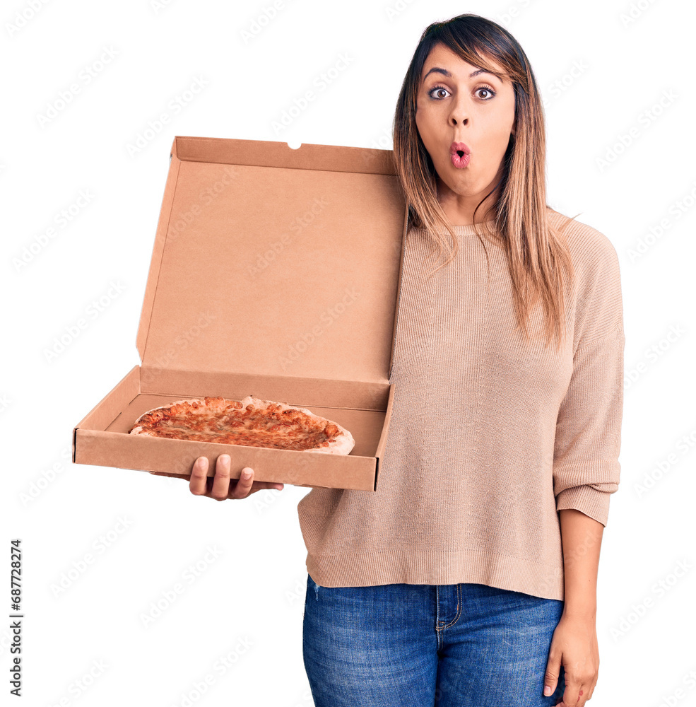 Young beautiful woman holding delivery cardboard box with pizza scared ...